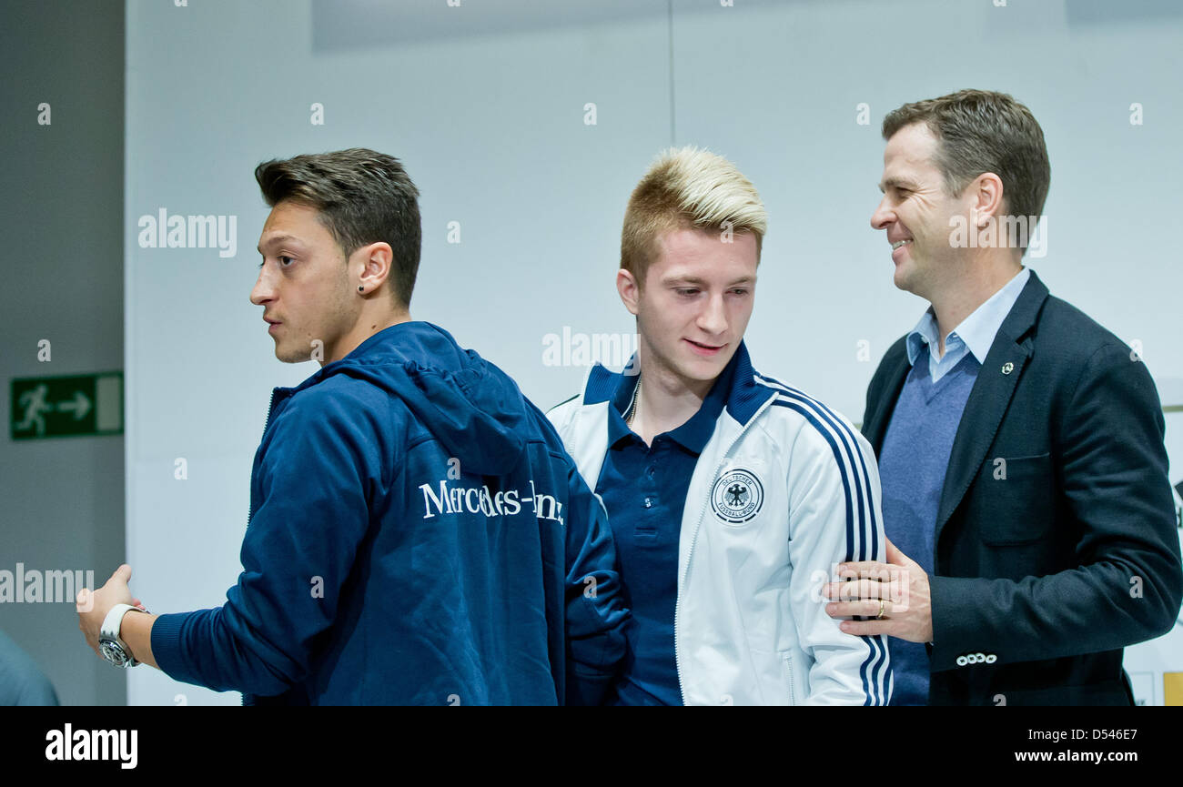 Players Mesut Oezil (L) and Marco Reus (C) and team manager Oliver Bierhoff of Germany attend ...