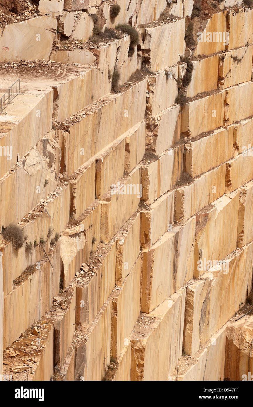Wall of a marble quarry with marks left after extraction of the blocks ...