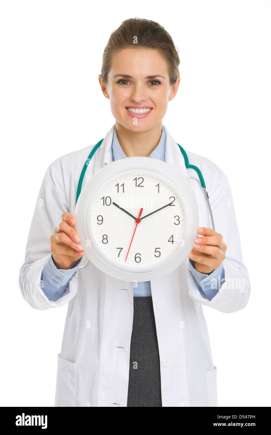 Smiling medical doctor woman showing clock Stock Photo - Alamy