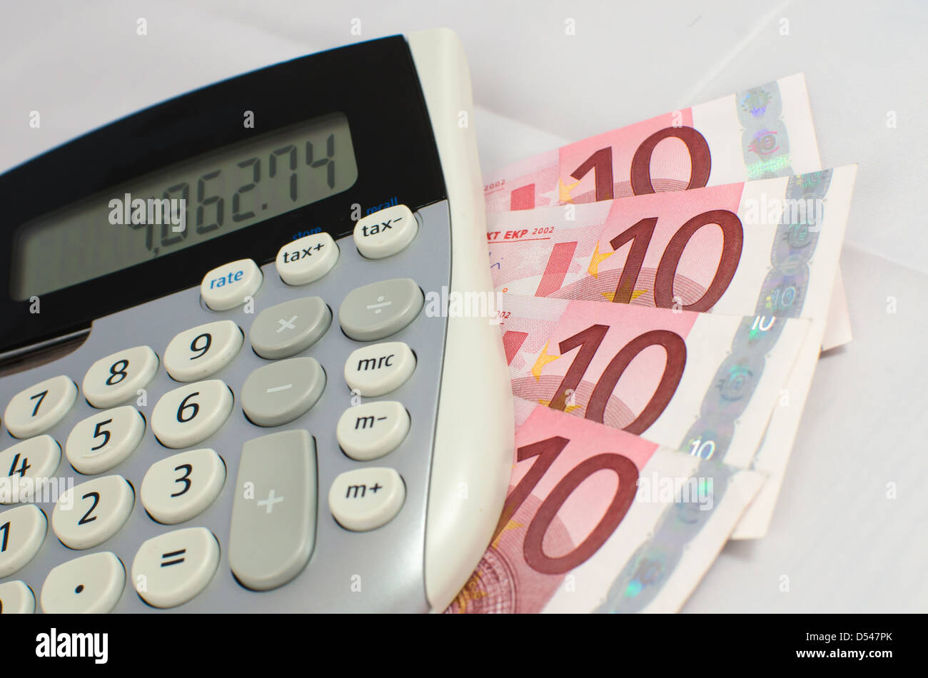 Isolated Calculator With Money Notes Stock Photo - Alamy