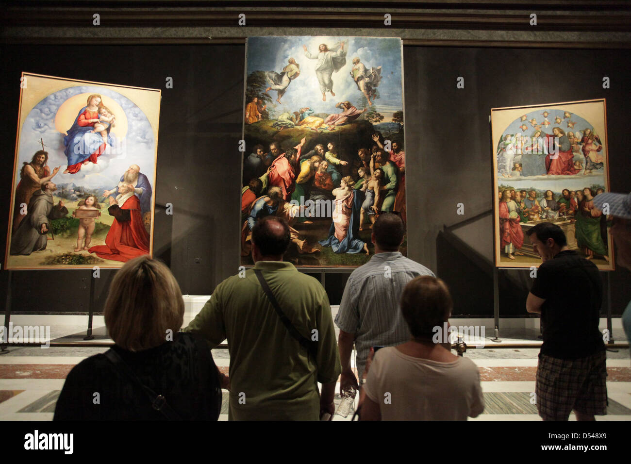 Views from Vatican city visitors look at (L-R) The Foligno Madonna ...