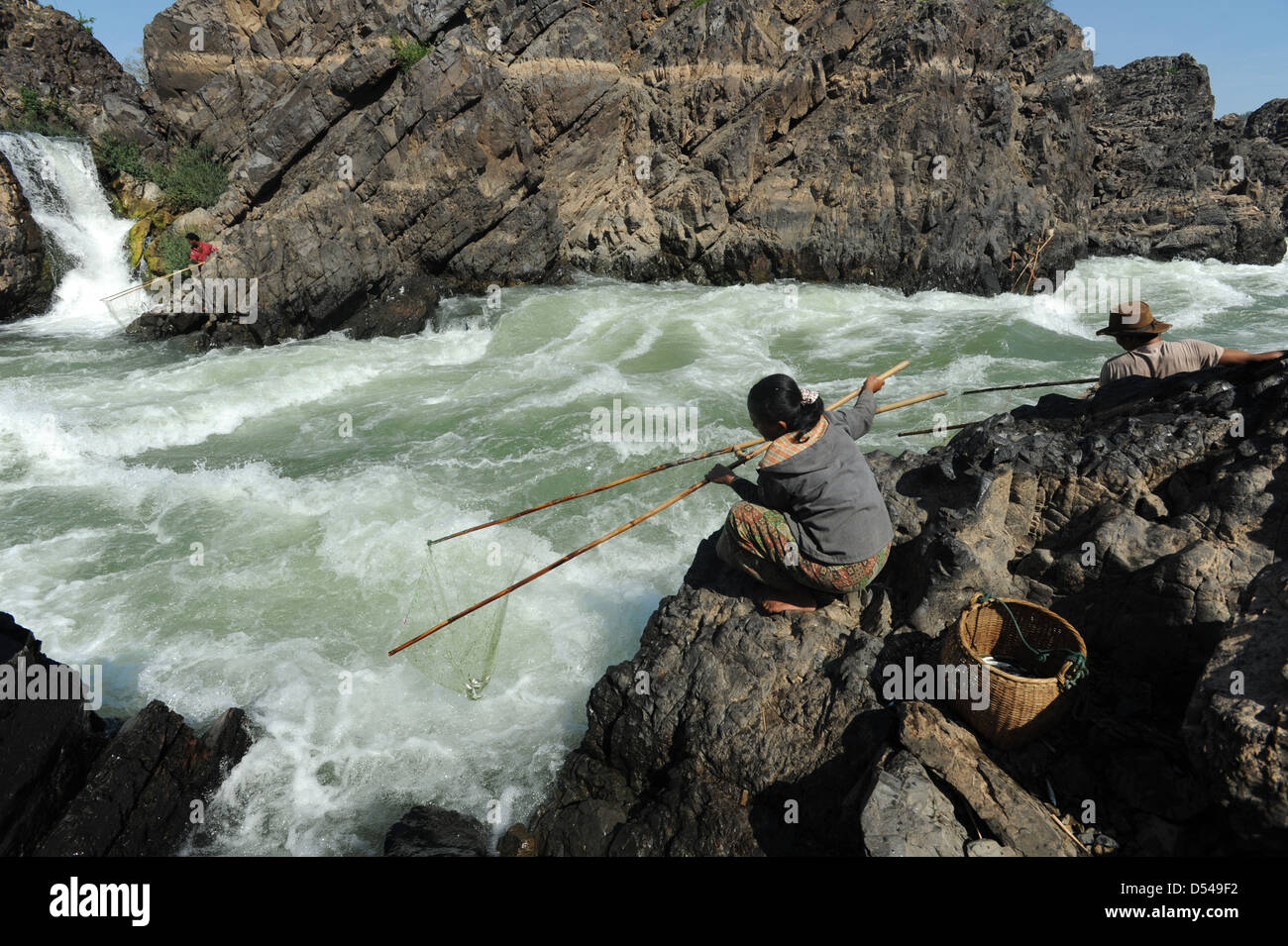 Fisherman fishing on river Mekong on Laos Stock Photo - Alamy