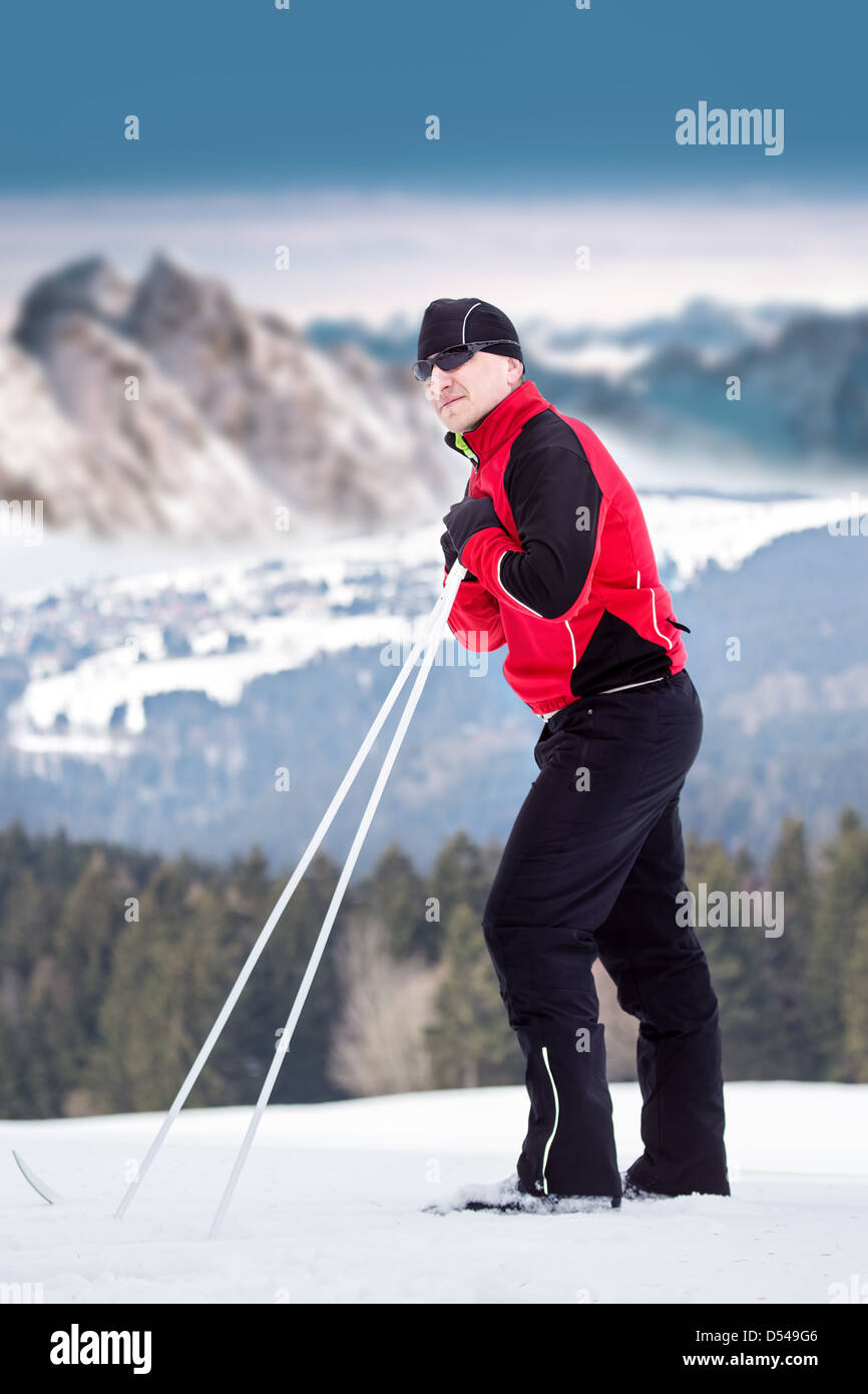 A man cross-country skiing in front of winter landscape Stock Photo - Alamy