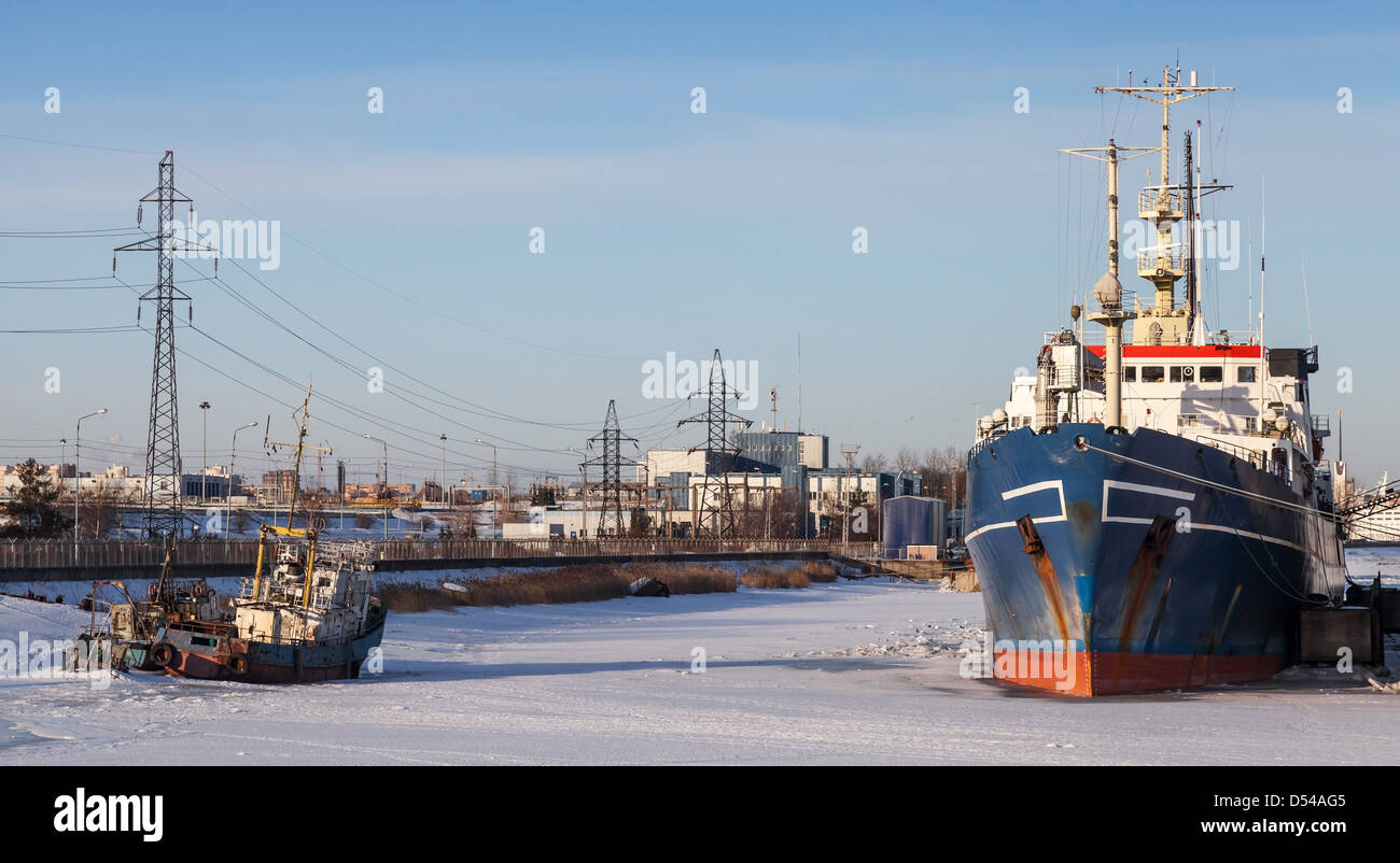 Ships moored in icy harbor. Cargo port of St.Petersburg, Russia Stock ...