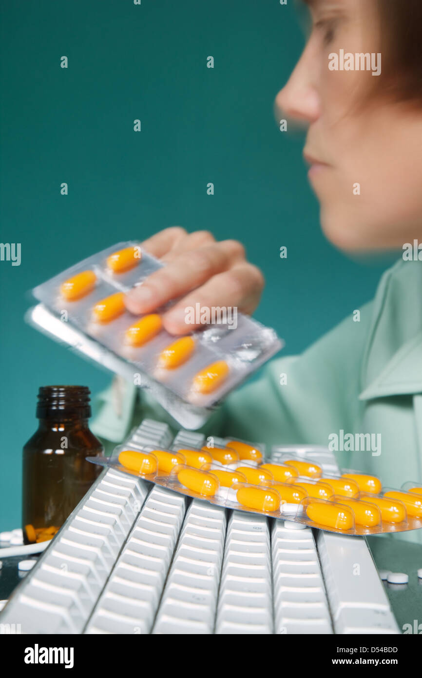 Berlin, Germany, a woman takes tablets at work Stock Photo - Alamy