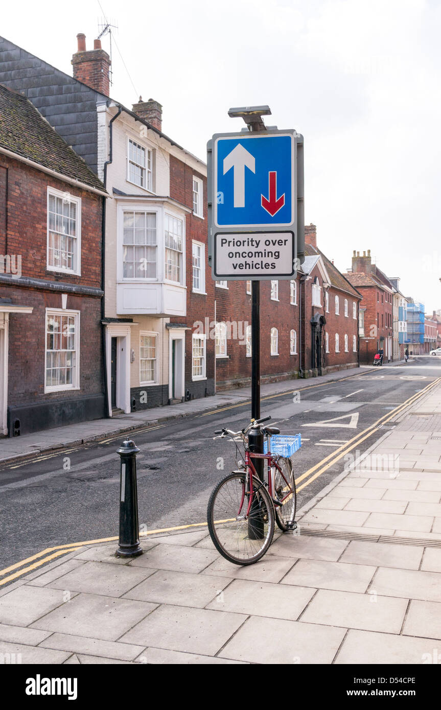 UK traffic sign with bicycle leaning against metal post Stock Photo - Alamy