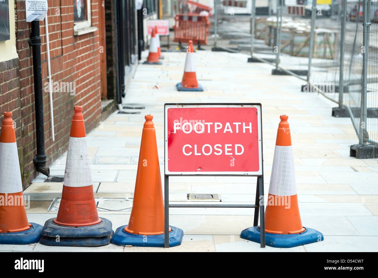 Footpath closed sign and bollard traffic cones Stock Photo - Alamy