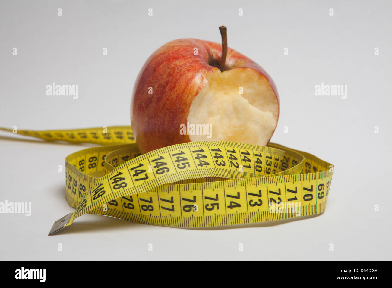 Bitten apple representing control in eating Stock Photo - Alamy