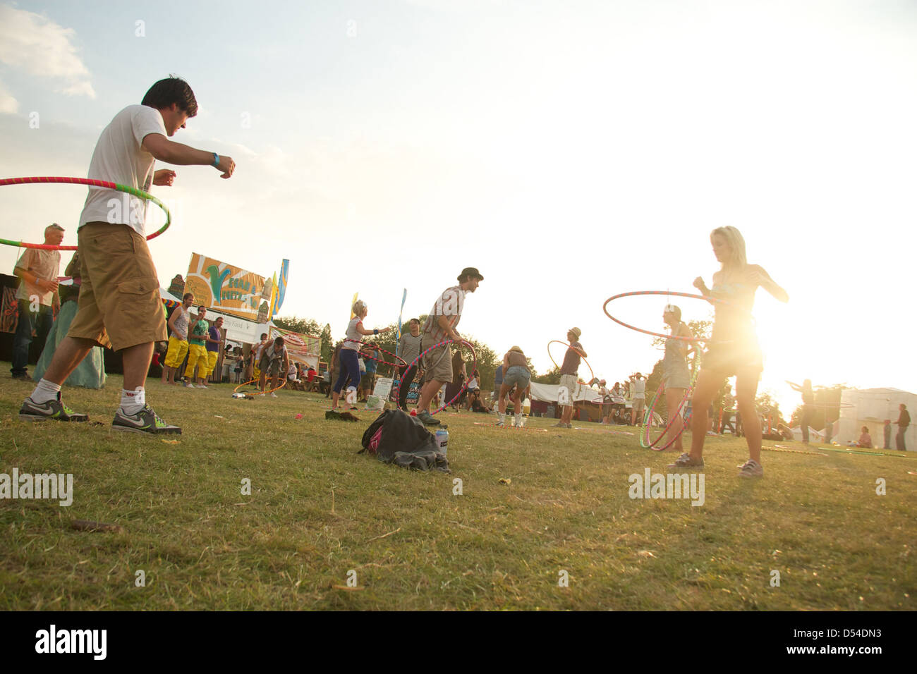 Festival goers at Secret Garden Party play with hula hoops in the sun ...