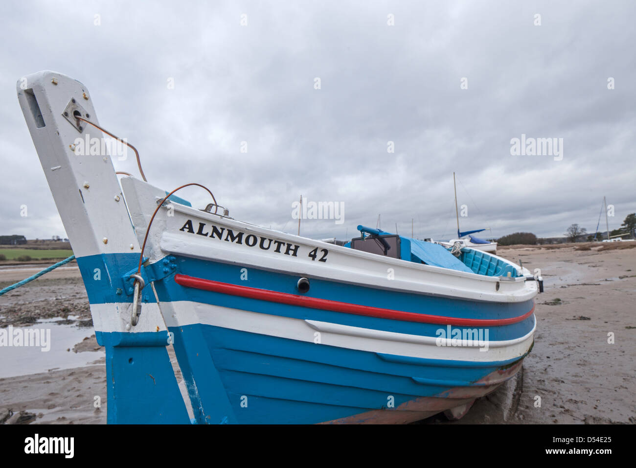 Alnmouth wooden fishing boat moored on the tidal River Aln Estuary ...