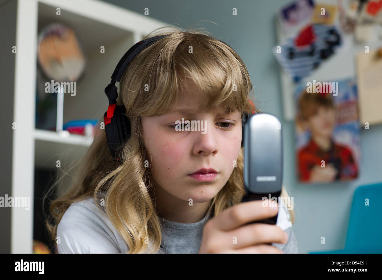 Berlin, Germany, a girl writes SMS and listens to music Stock Photo - Alamy