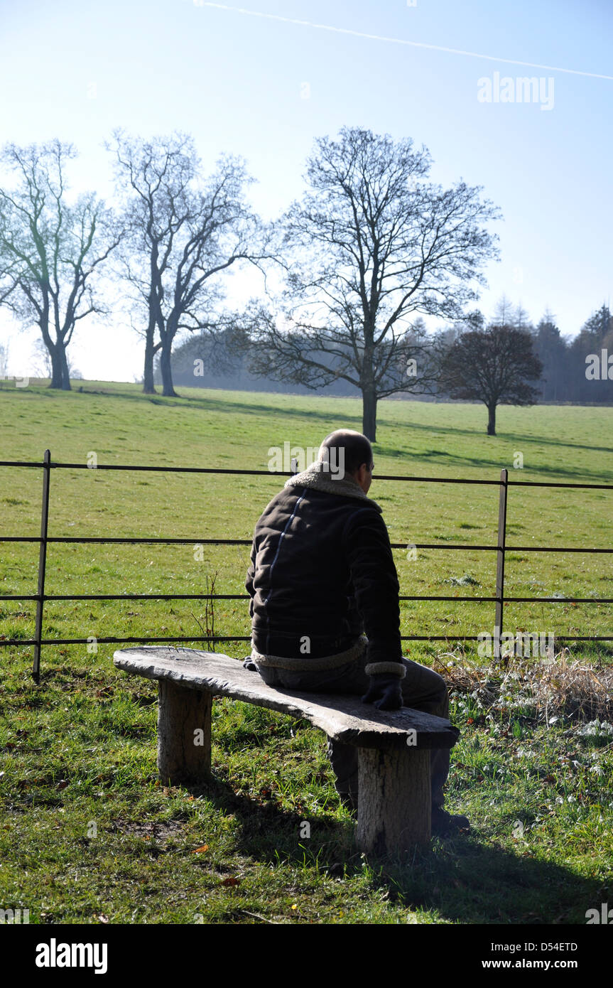 Man sitting on bench Stock Photo - Alamy