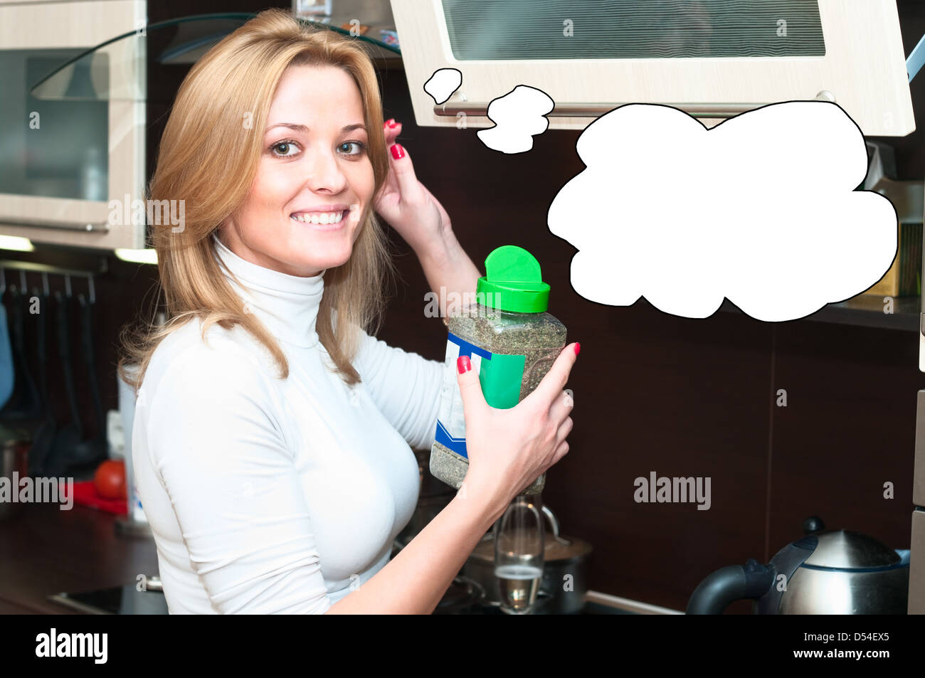 Beautiful happy smiling woman in kitchen interior. One person only ...