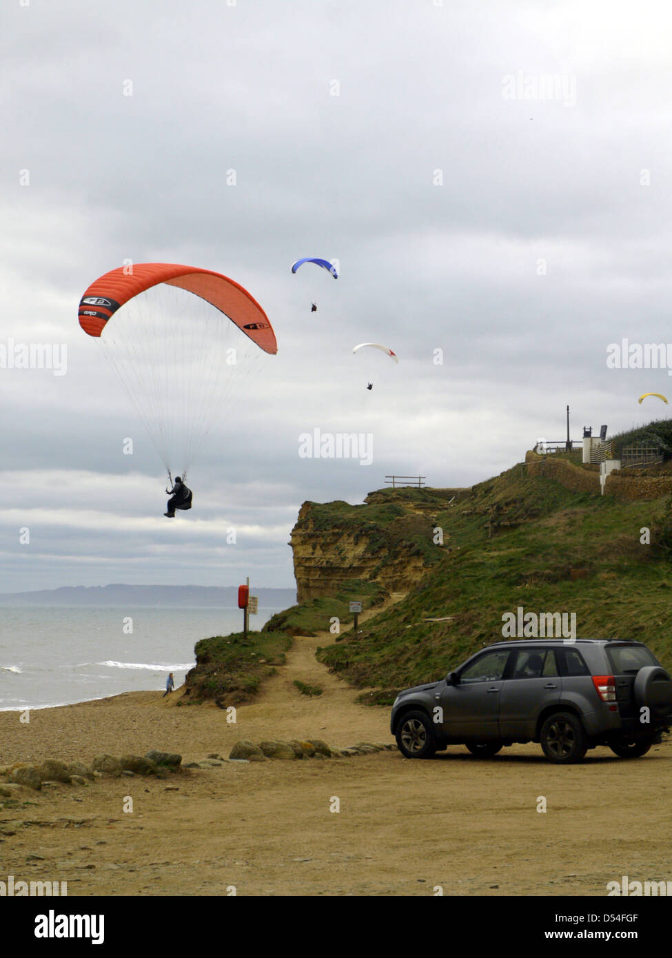 Paraglider above coastal car park Stock Photo - Alamy