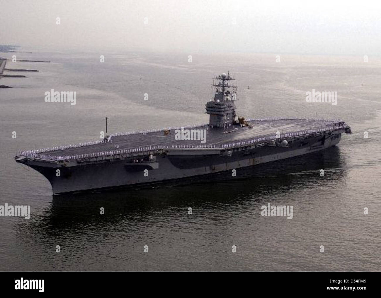 The USS Dwight D. Eisenhower (CVN-69), an aircraft carrier, plays a ...