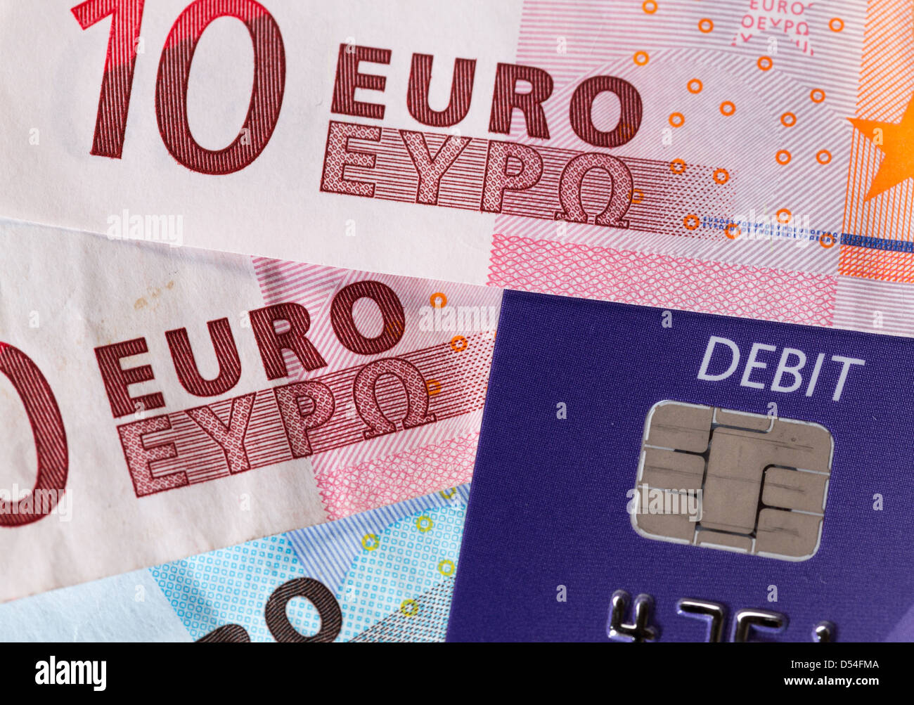 Debit word on plastic card on Euro notes Stock Photo - Alamy