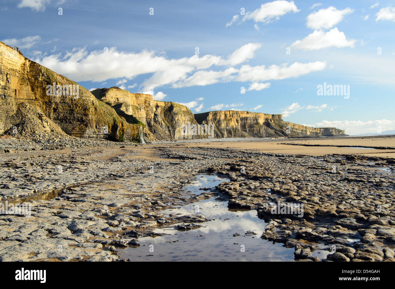 Waterfall over cliffs at Dunraven Bay, Southerndown, South Wales, UK ...