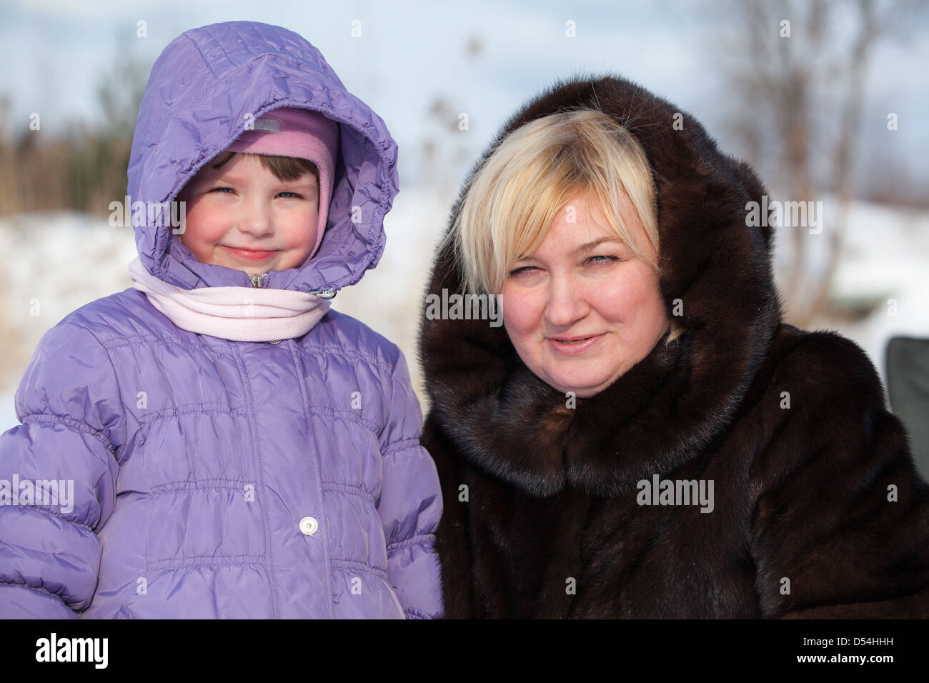 Mother and child in winter clothes standing together outdoor Stock ...