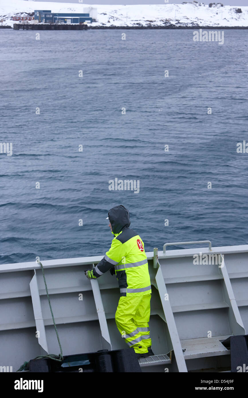 crewman working on ships ropes on board hurtigruten passenger ship ...