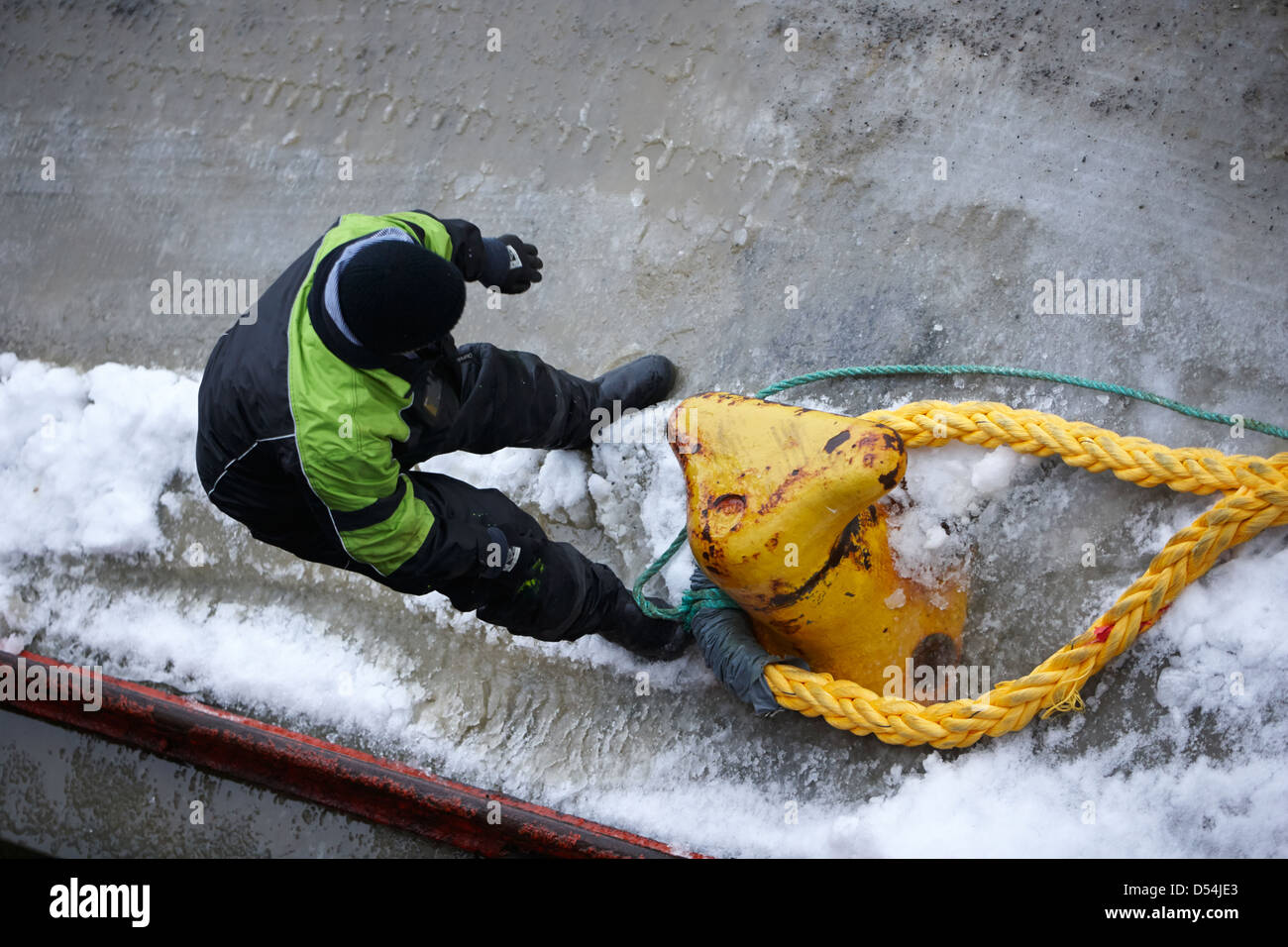dock worker pulling on ships ropes for hurtigruten passenger ship on ...