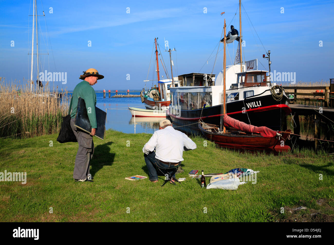 Hiddensee Island, Painter at oldtimer ship WILLI at Kloster harbor ...