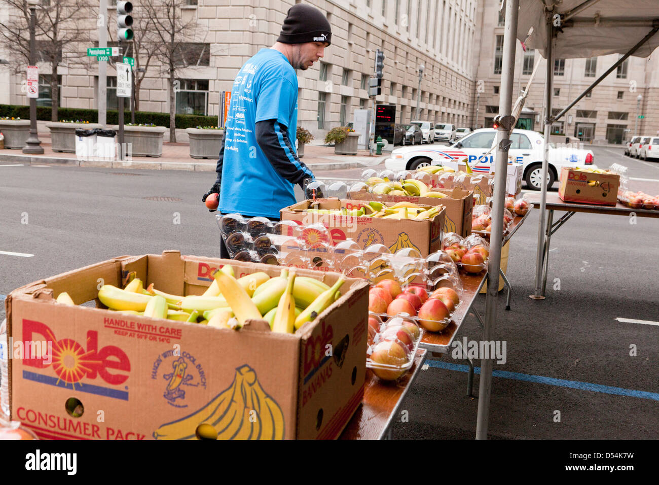 Marathon runner reaching for fruit after race Stock Photo - Alamy