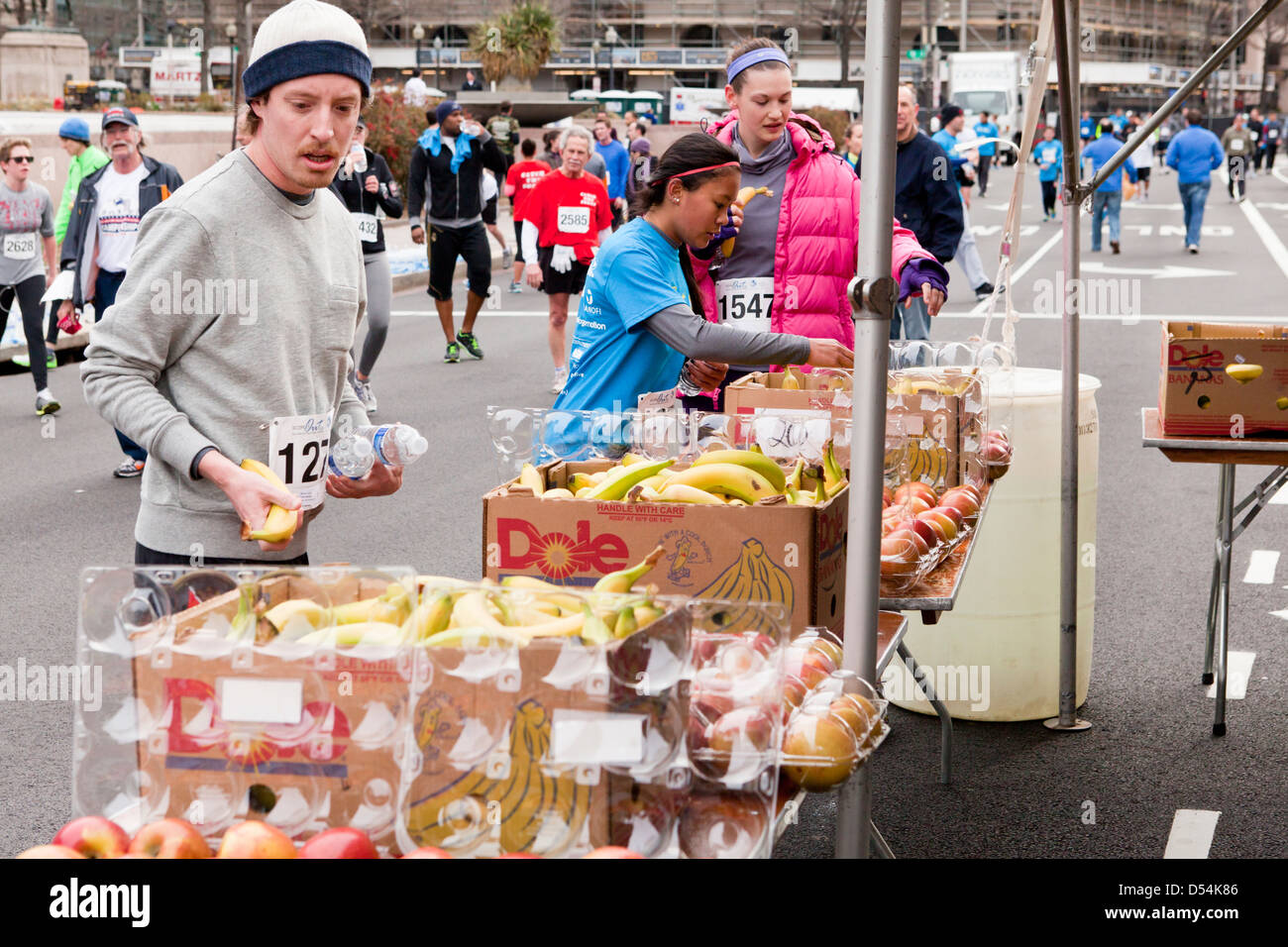 Marathon runner reaching for fruit after race Stock Photo - Alamy
