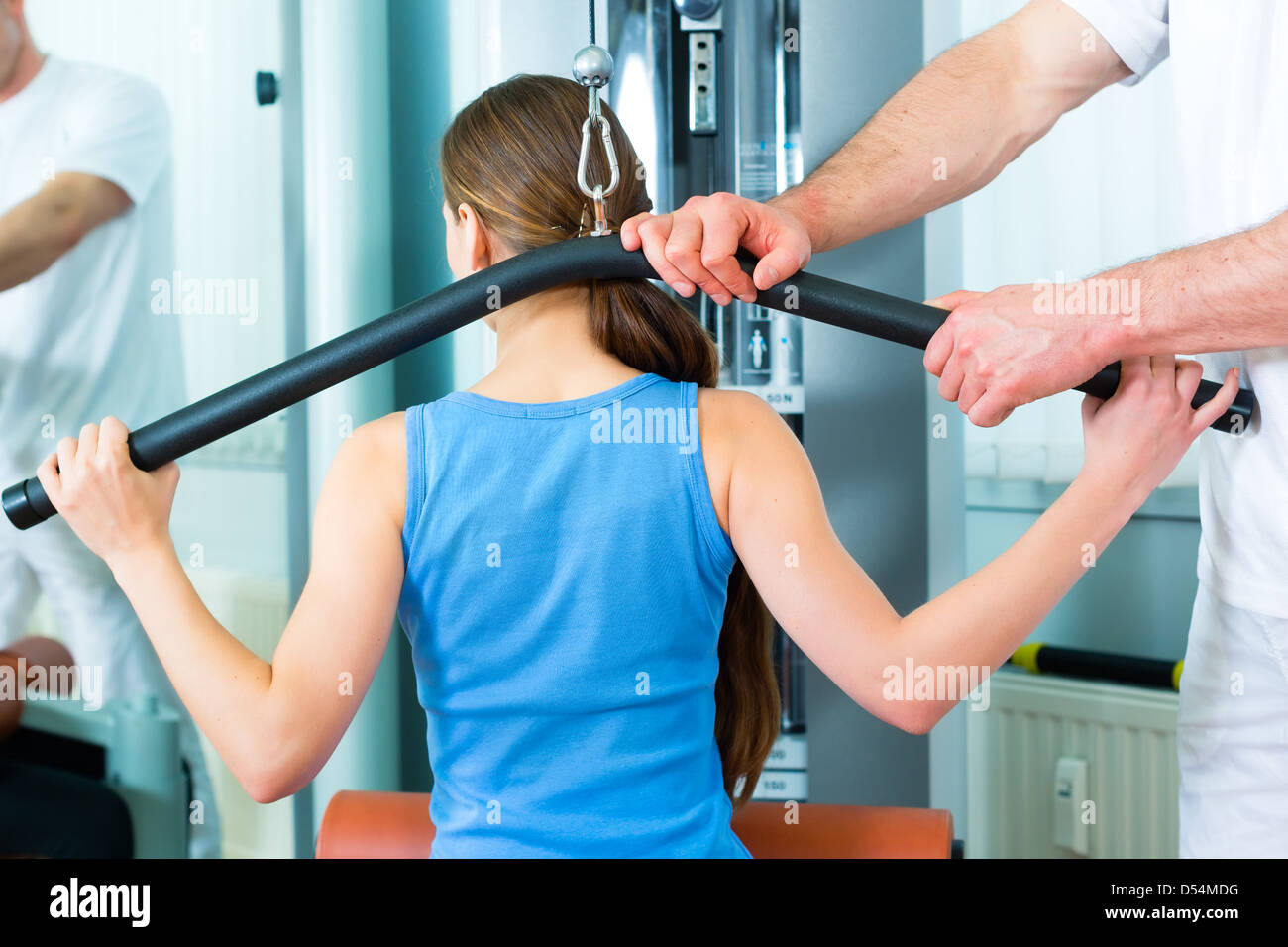 Patient at the physiotherapy making physical exercises with her ...