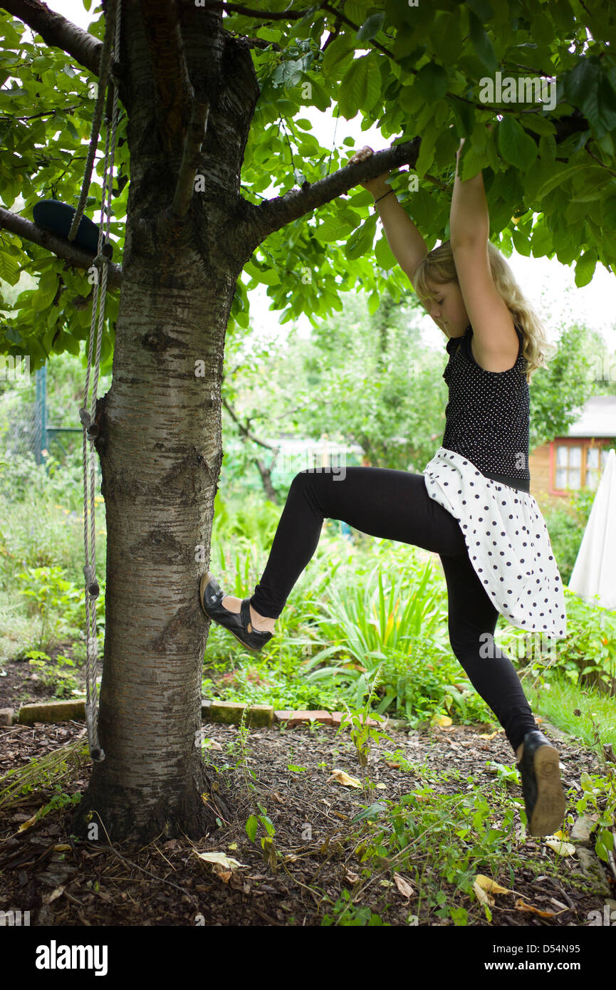 Berlin, Germany, a girl hangs on a tree in the garden Stock Photo - Alamy
