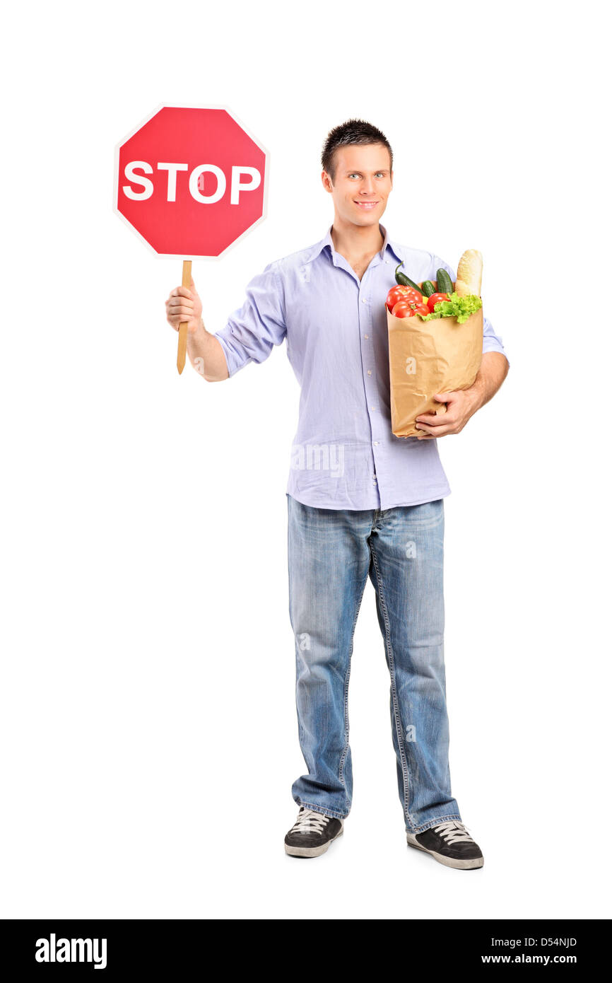 Stop and shop here Full length portrait of a male holding a paper bag ...