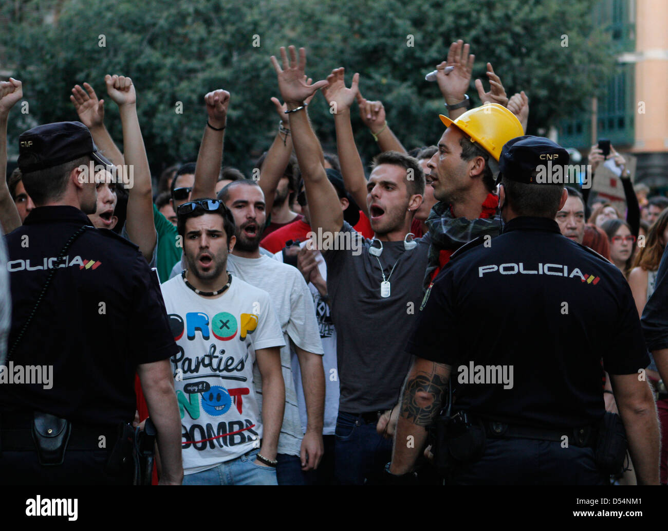 Demonstrators protest near the police during a general strike day in ...