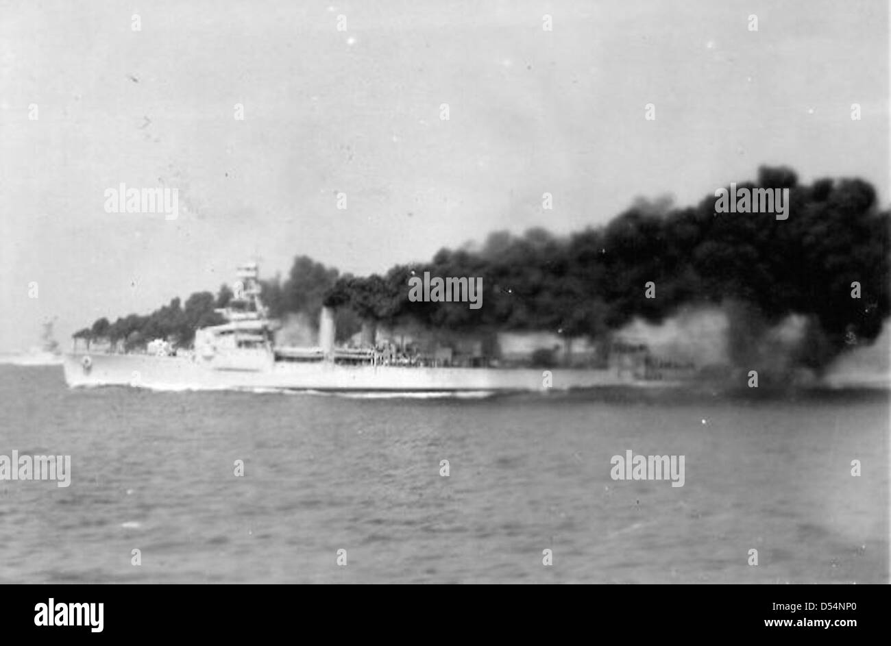 Two U.S. Navy light cruisers create a smoke screen as part of a naval ...