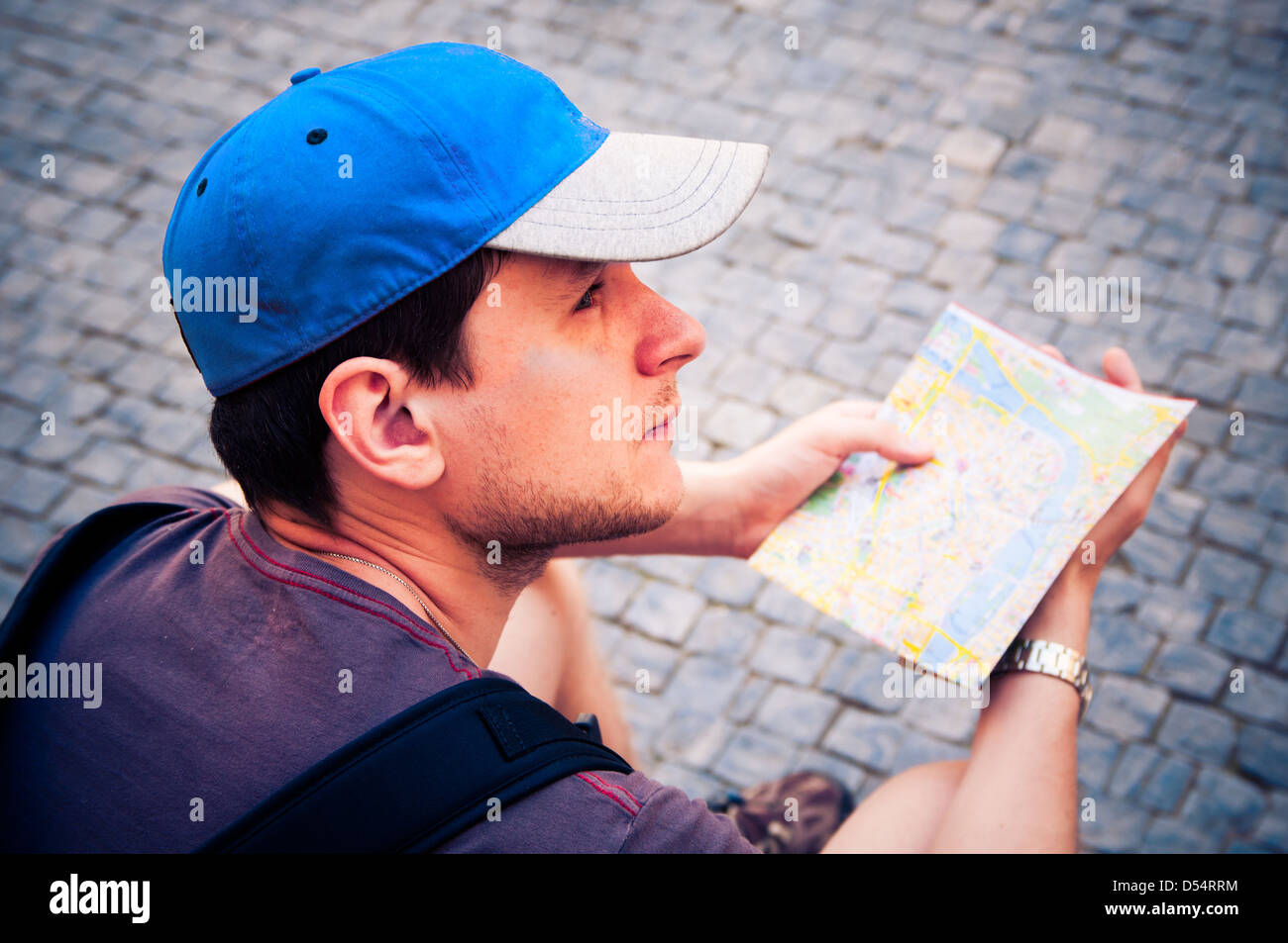Tourists on the street looking at a guide Stock Photo - Alamy