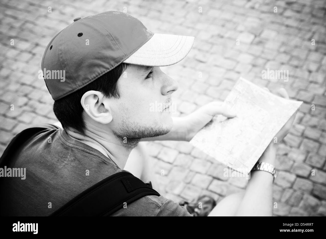 Tourists on the street looking at a guide Stock Photo - Alamy