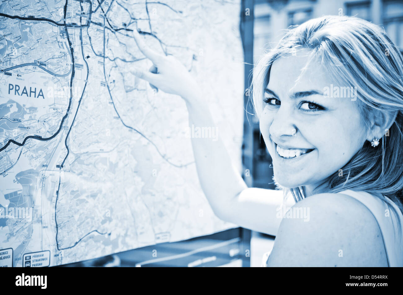 Young woman is looking on a map Stock Photo - Alamy