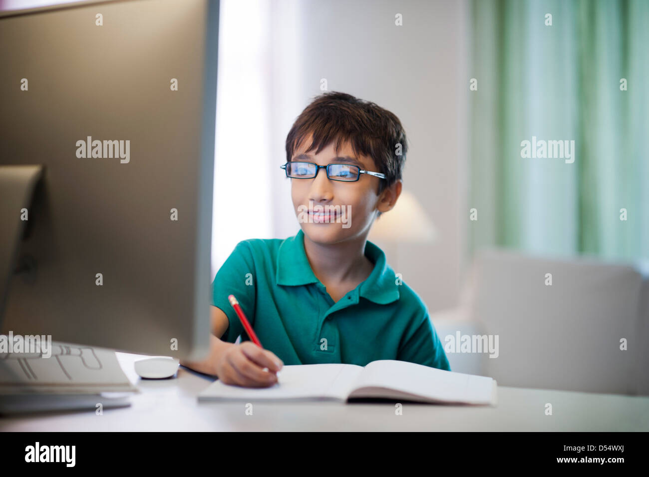 Boy studying in front of a desktop pc Stock Photo - Alamy