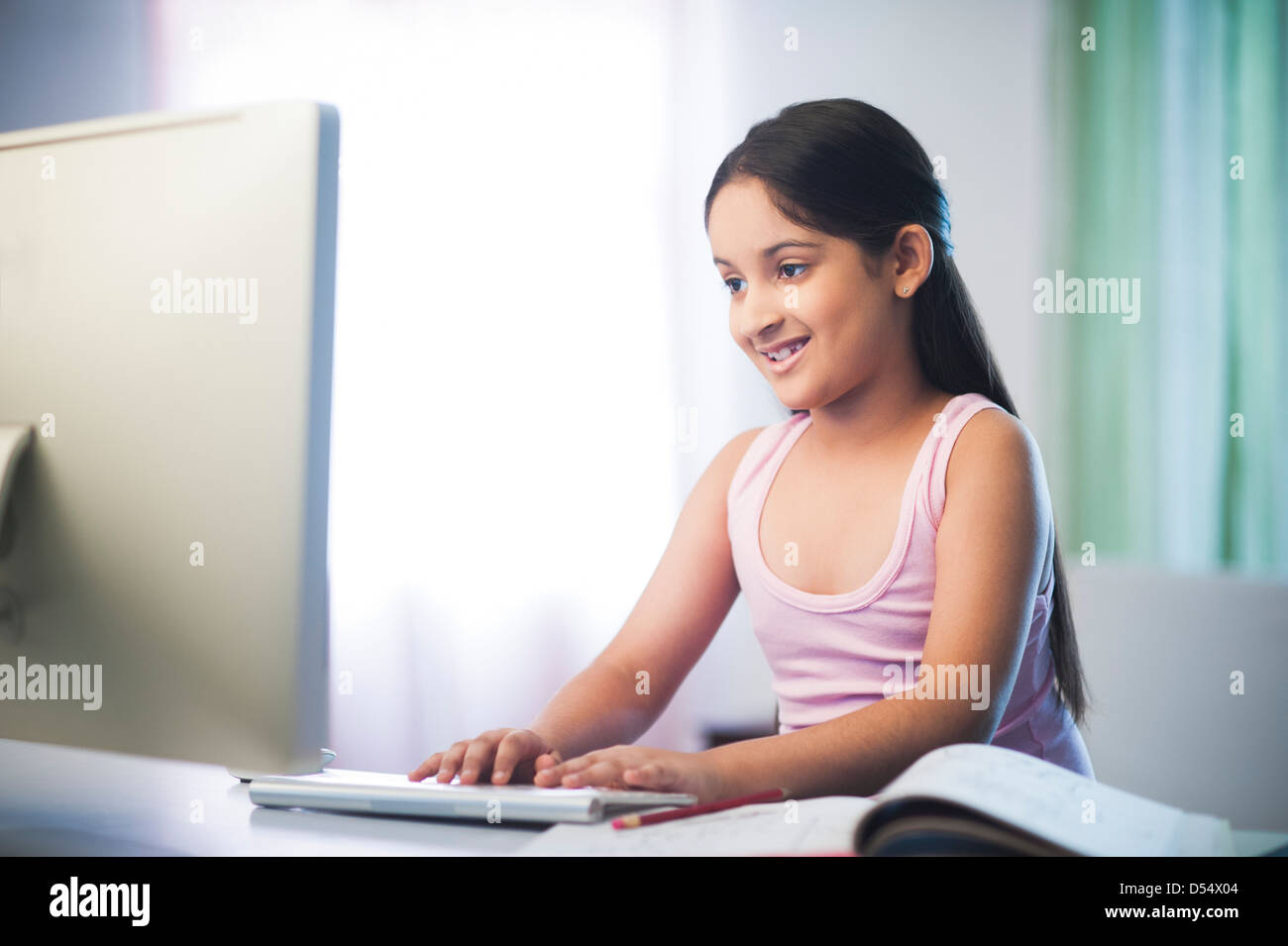 Indian girl writing in notebook hi-res stock photography and images - Alamy