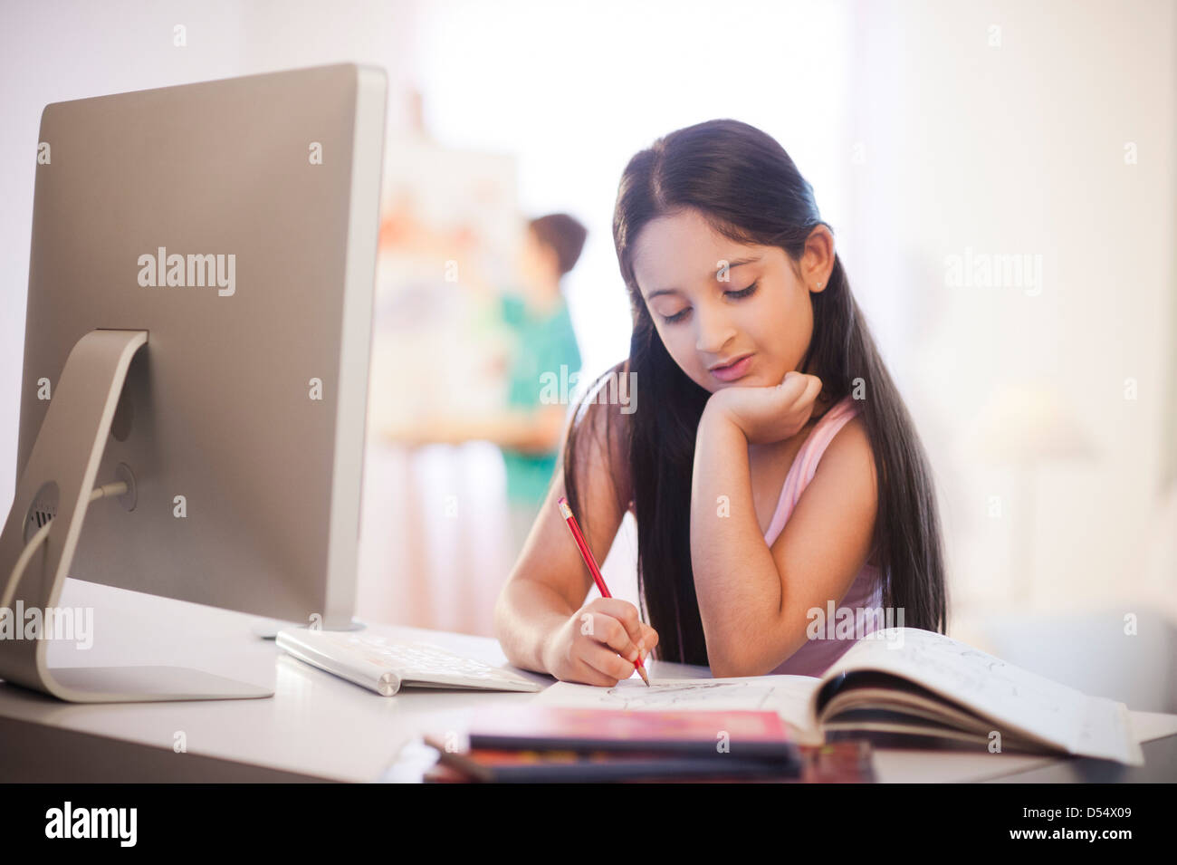Girl studying in front of a desktop pc Stock Photo - Alamy