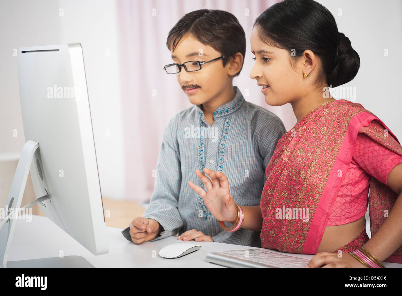 Children imitating like couple using a desktop pc at home Stock Photo ...