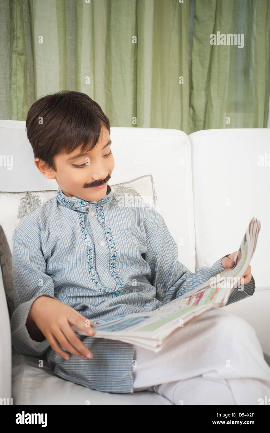 Boy reading newspaper hi-res stock photography and images - Alamy