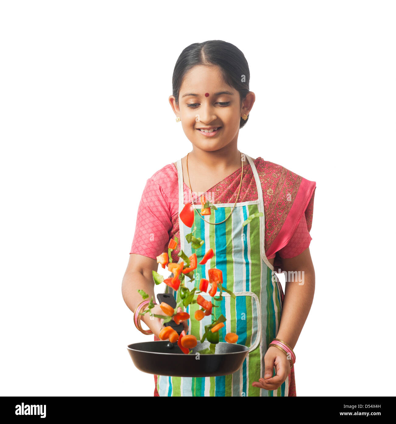 Girl imitating like woman cooking vegetables Stock Photo - Alamy