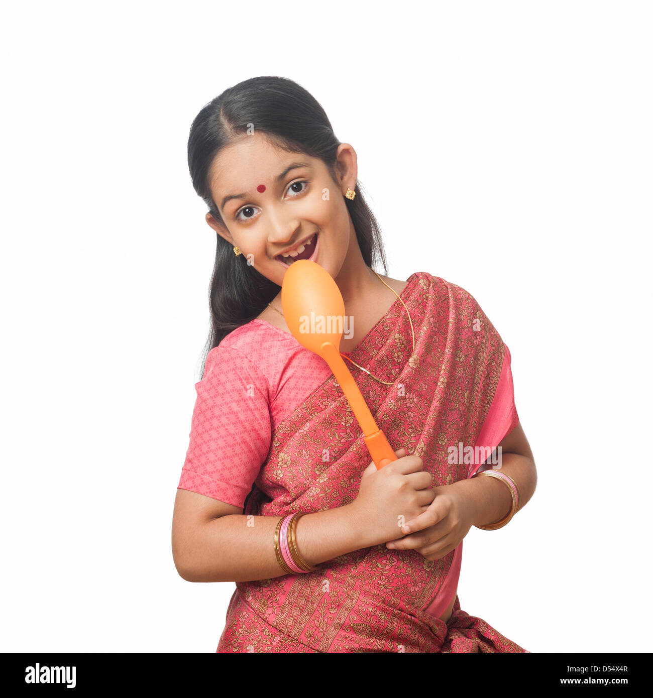 Girl imitating like woman holding a spoon Stock Photo - Alamy