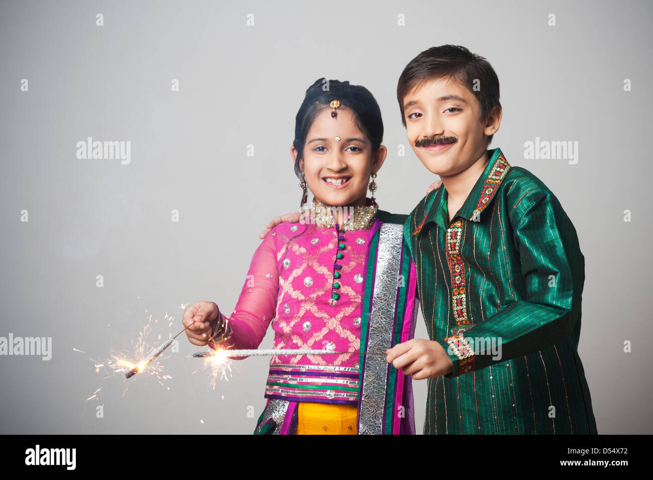 Two children imitating like couple celebrating Diwali festival with ...