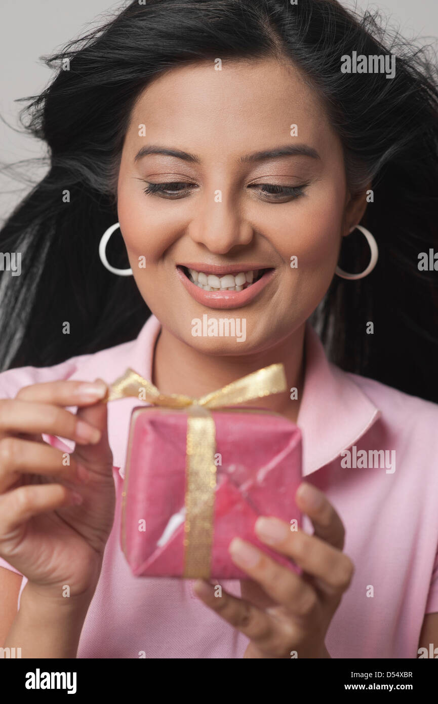 Woman opening a gift box and smiling Stock Photo - Alamy