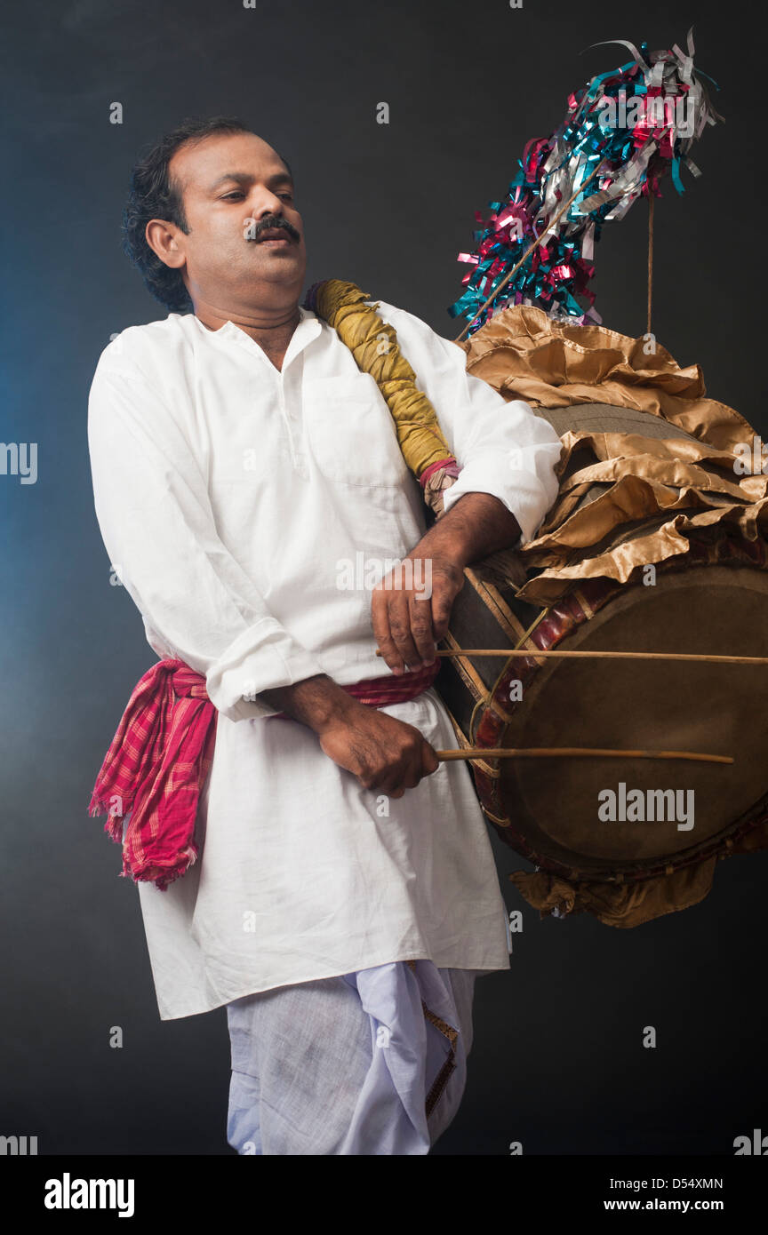 Man playing musical instrument dhol hi-res stock photography and images ...