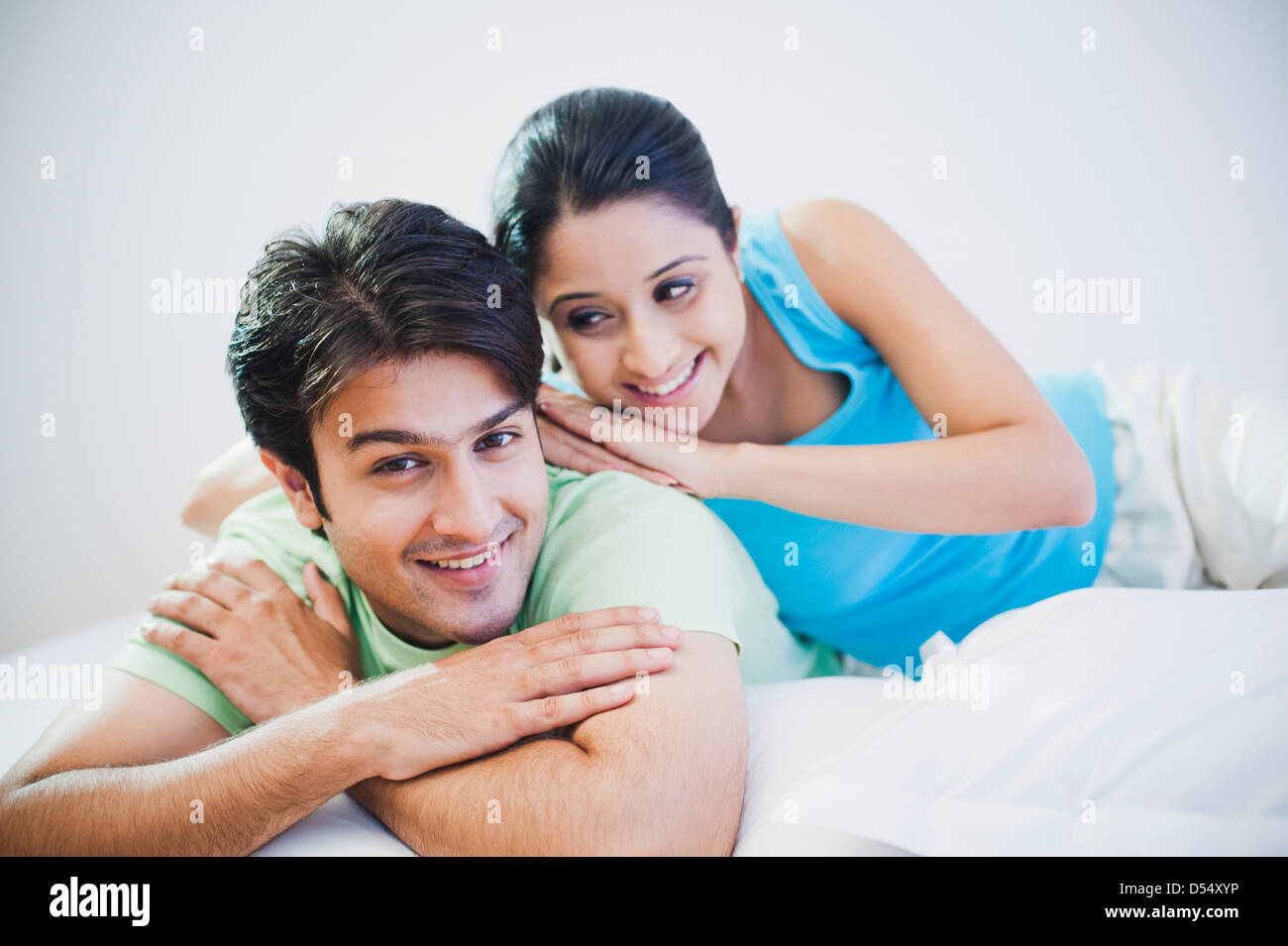 Romantic couple lying on the bed Stock Photo - Alamy