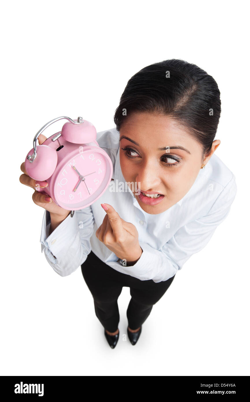Angry businesswoman pointing towards an alarm clock Stock Photo - Alamy Angry businesswoman pointing towards an alarm clock Stock Photo - Alamy
