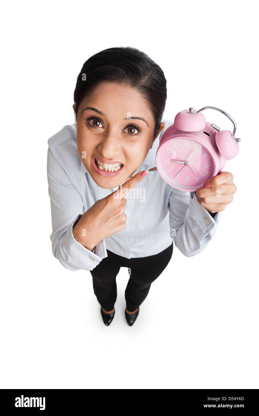 Angry businesswoman pointing towards an alarm clock Stock Photo - Alamy Angry businesswoman pointing towards an alarm clock Stock Photo - Alamy
