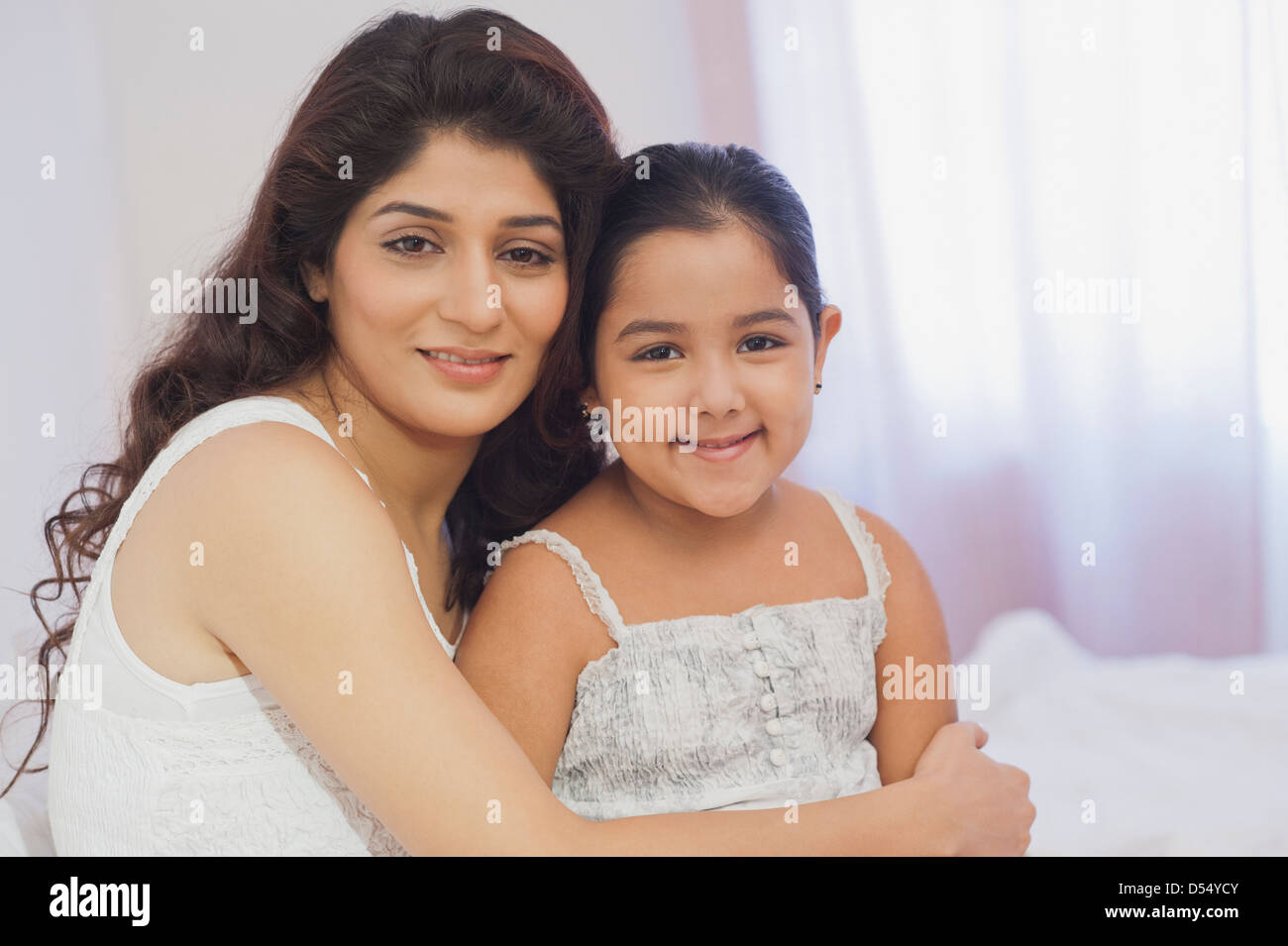 Woman hugging her daughter Stock Photo - Alamy