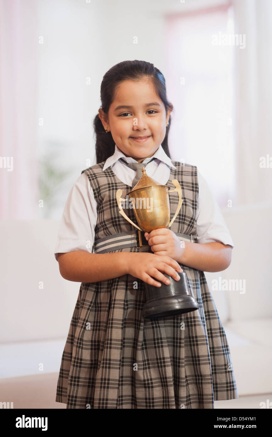 Portrait of a girl holding a trophy and smiling Stock Photo - Alamy